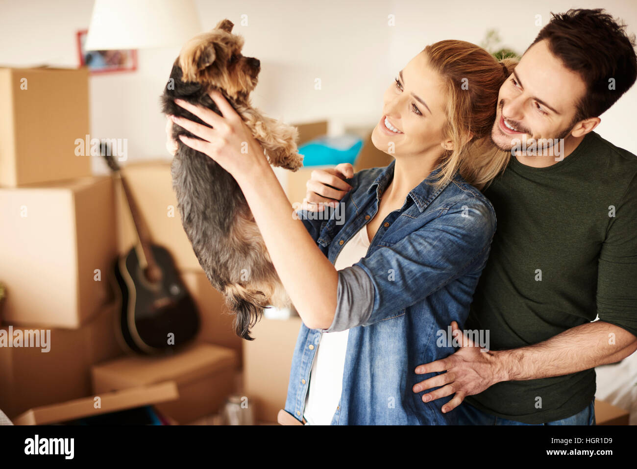 Woman is raising her cute dog Stock Photo - Alamy