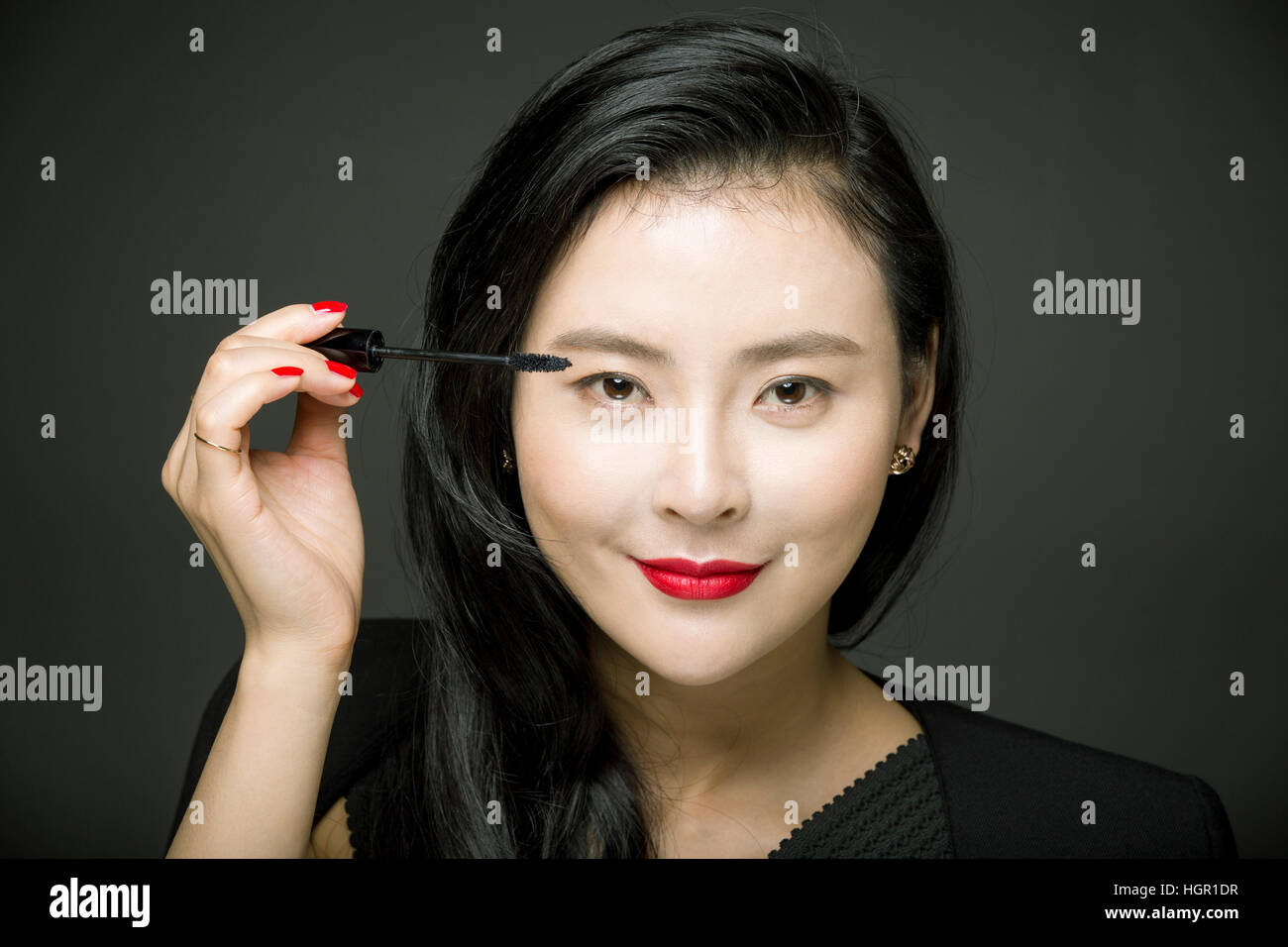 Woman applying mascara using hi-res stock photography and images - Alamy