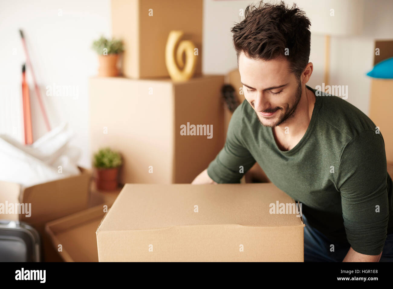 Man with heavy cardboard box Stock Photo - Alamy