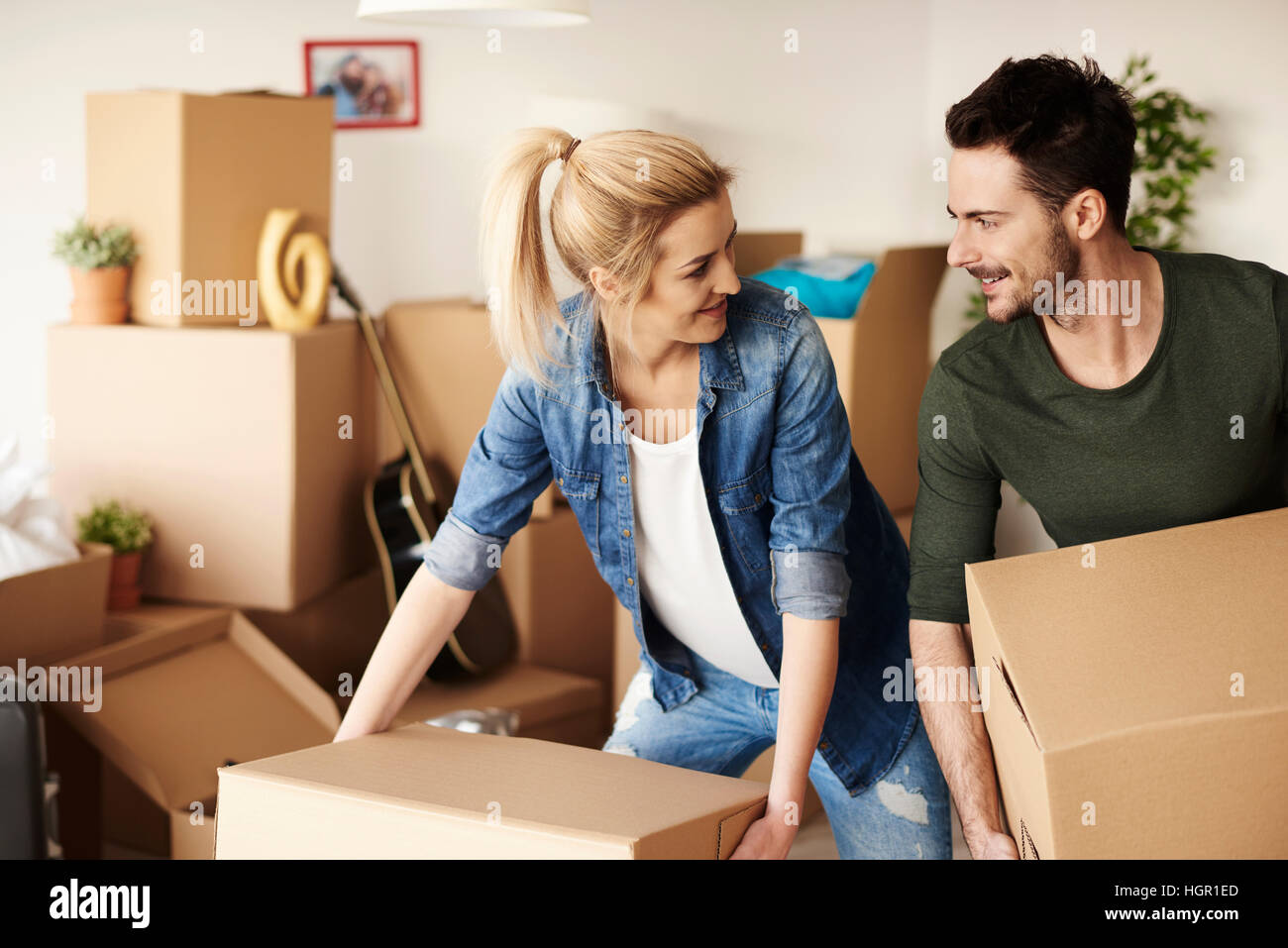Loving couple unpacking stuff from cartons Stock Photo - Alamy