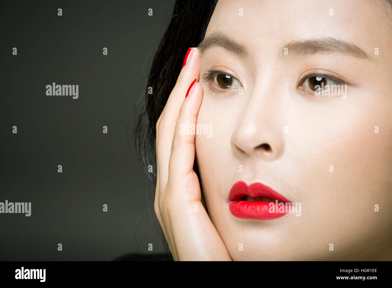 Portrait of young woman with red lips and red fingernails Stock Photo ...