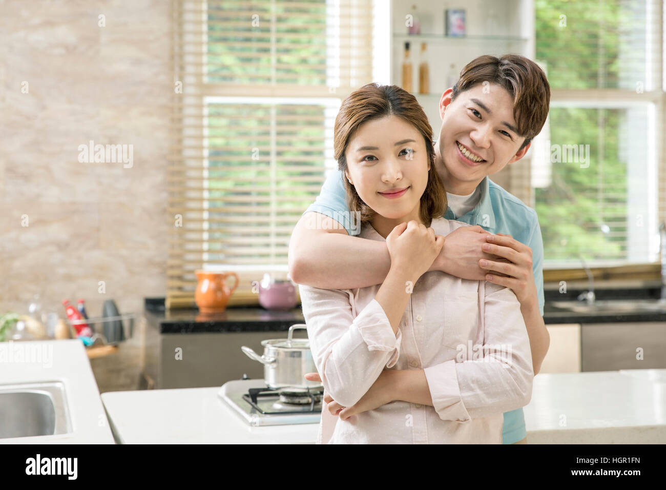 Portrait of young harmonious couple hugging Stock Photo - Alamy