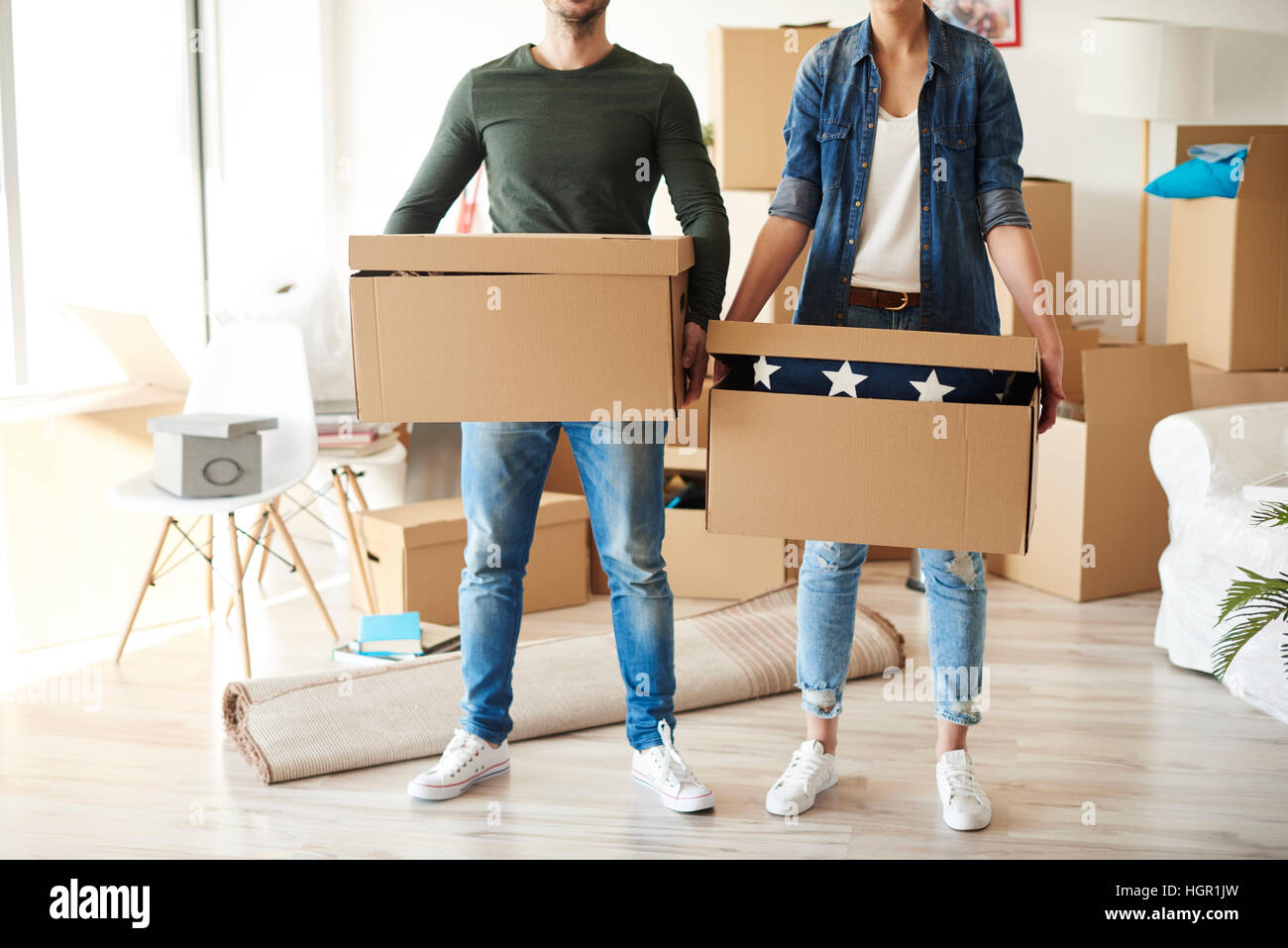 Front view of couple with cardboard boxes Stock Photo - Alamy