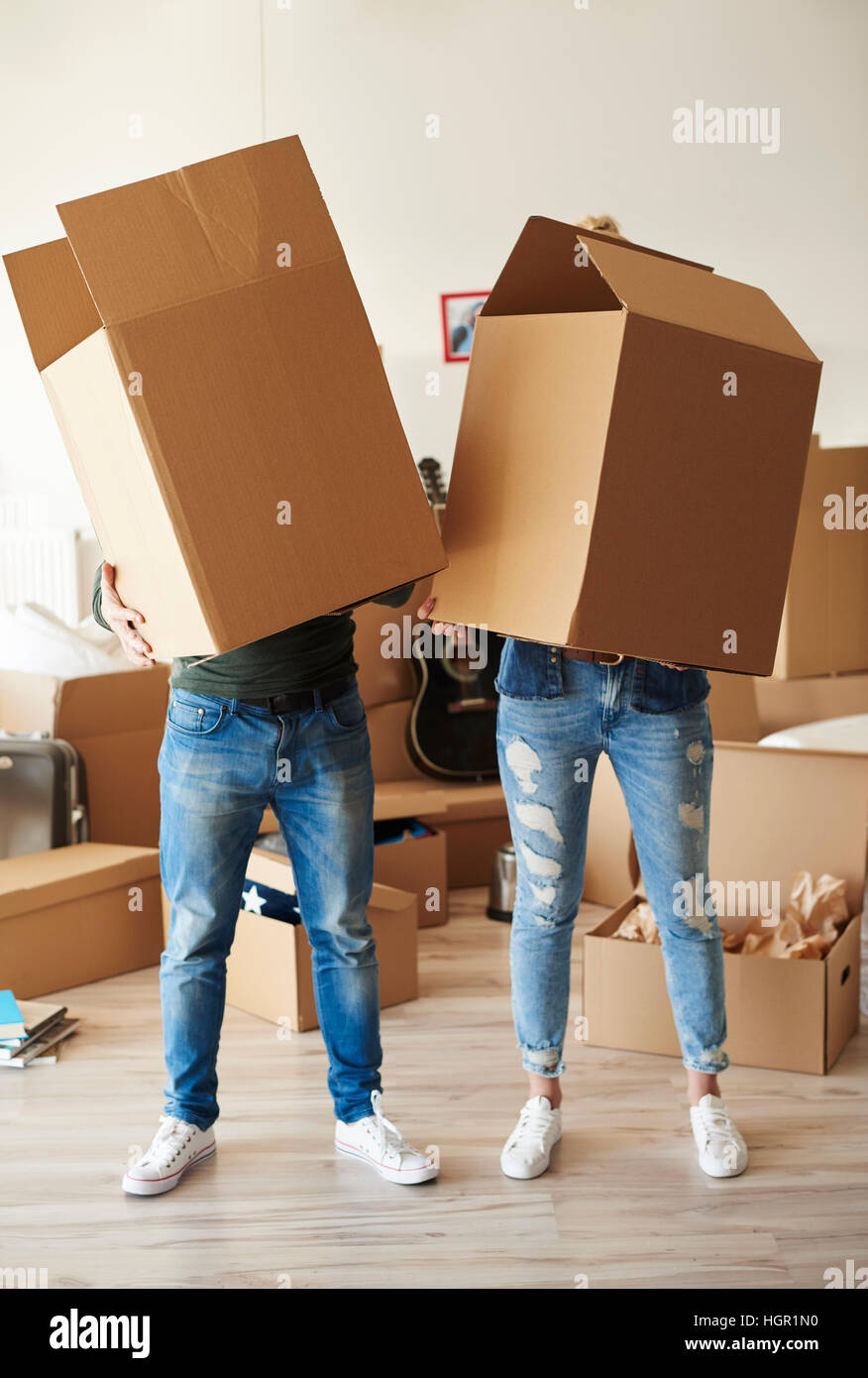 Couple faces behind cardboard boxes Stock Photo - Alamy