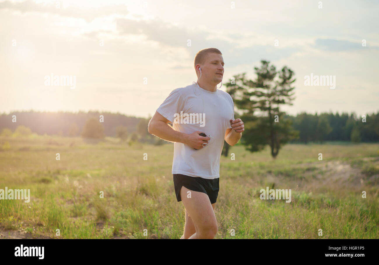 Muscular male runner running hi-res stock photography and images - Alamy