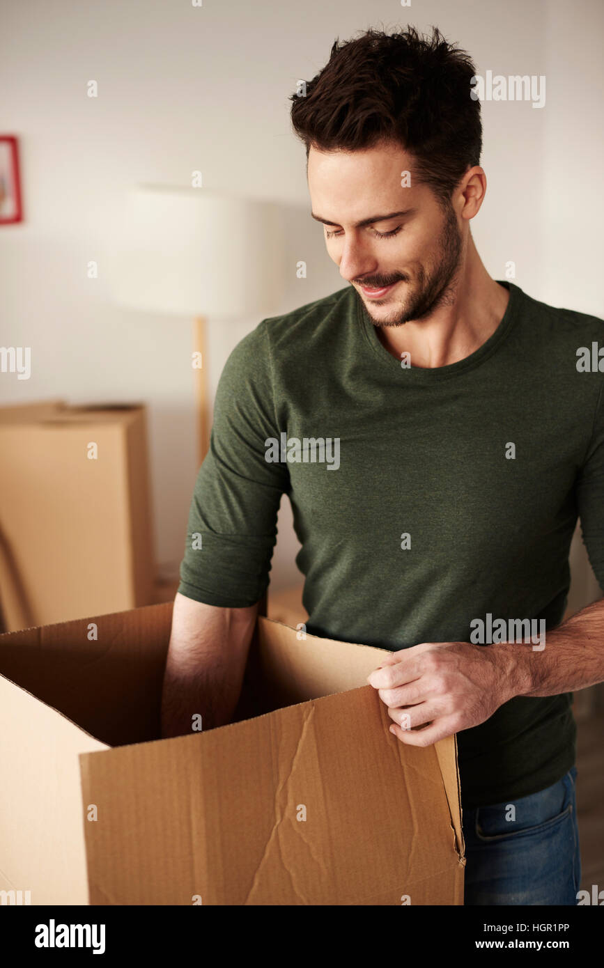 Man taking his stuff out from the cardboard box Stock Photo - Alamy