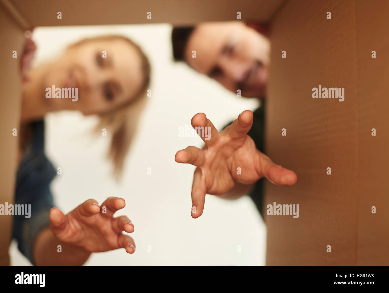 Man reaching into box hi-res stock photography and images - Alamy