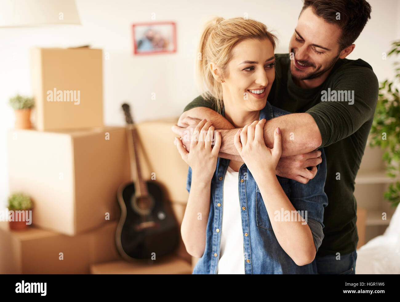 Couple hugging in new house Stock Photo - Alamy