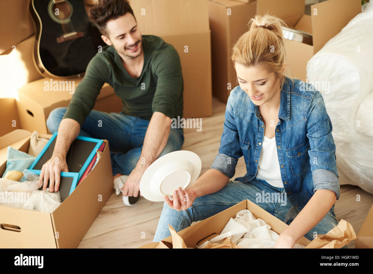 Unpacking stuff from the moving boxes Stock Photo - Alamy