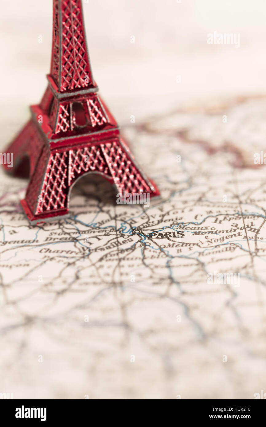 Paris name at a map with red Eiffel tower miniature (blurred copy space ...