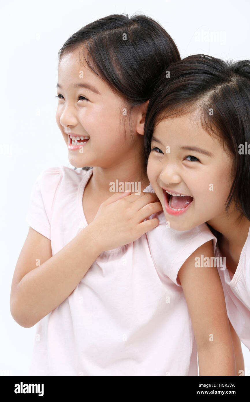 Smiling twin girls Stock Photo - Alamy