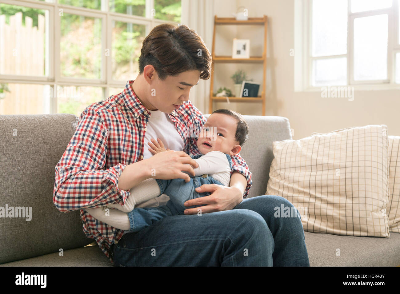 Father taking care of his baby Stock Photo - Alamy