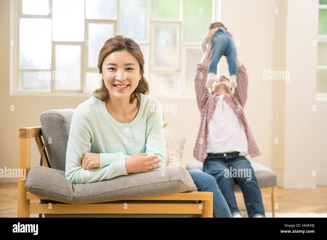 Smiling mother and her family Stock Photo - Alamy