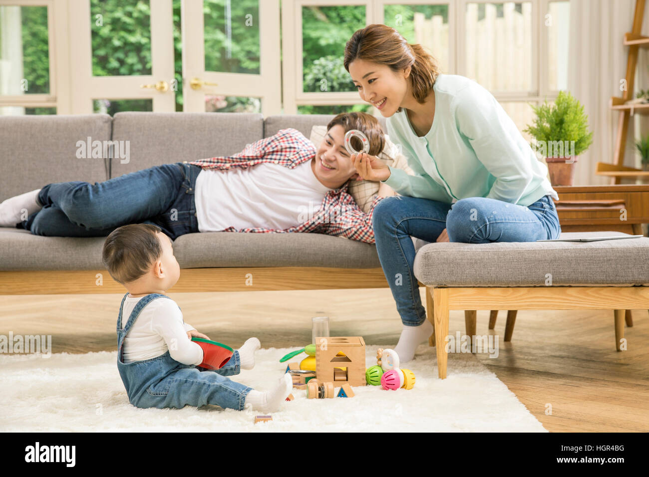 Harmonious family with baby Stock Photo - Alamy