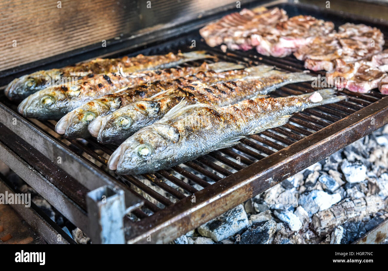 Fish and steak on the charcoal grill together. Home barbecue picnic ...