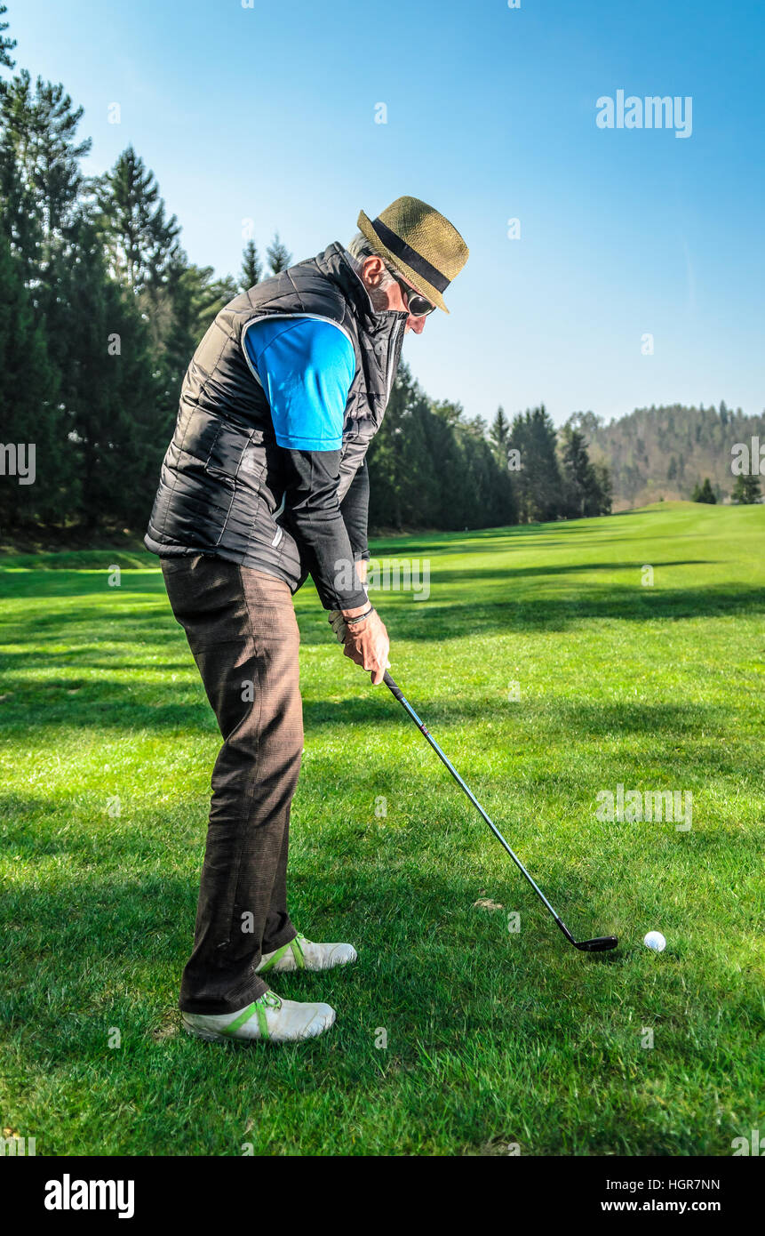 Senior citizen is playing golf. Active retirement. A man is golfing to ...