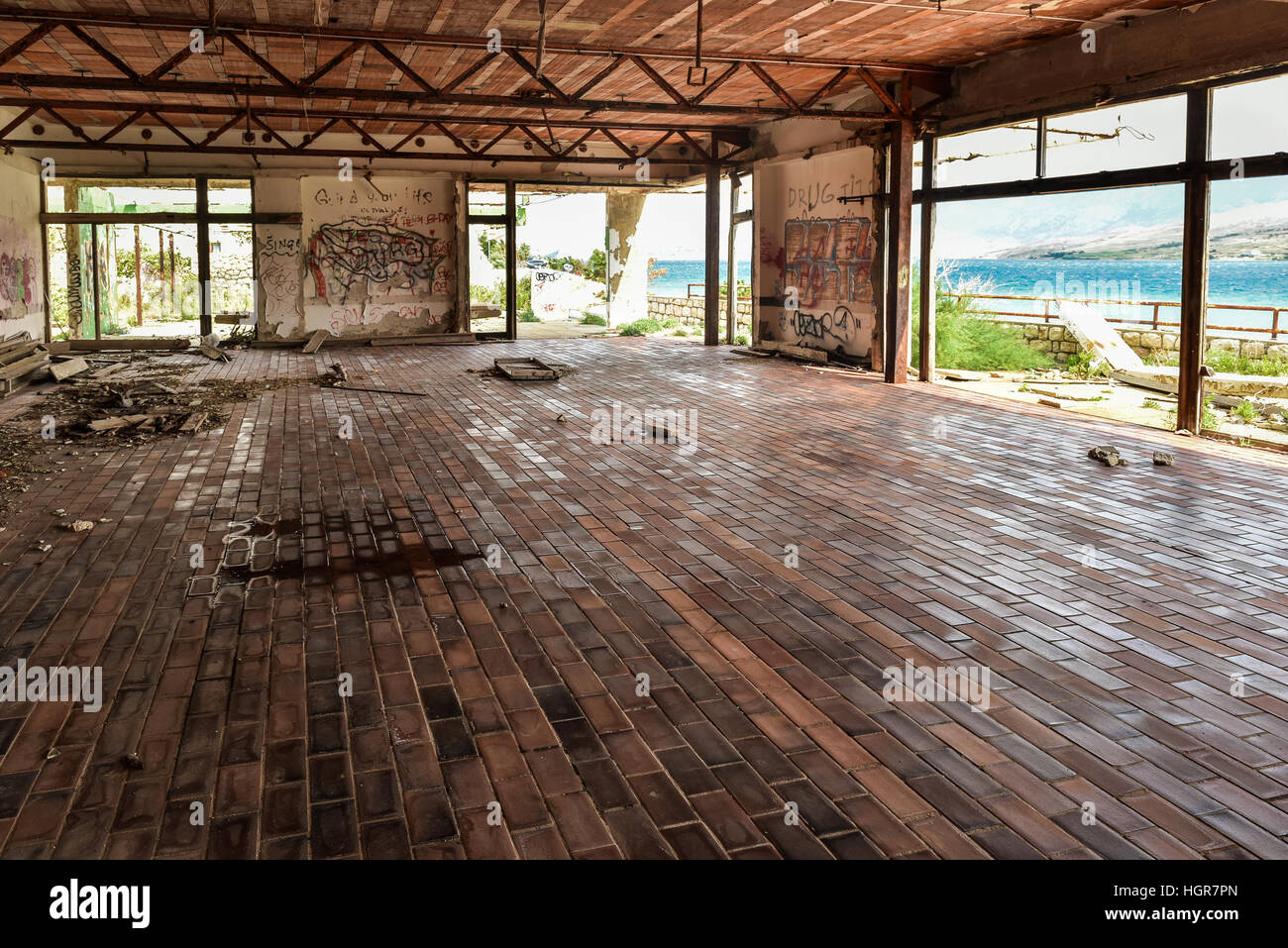 Ruins of abandoned hotel building with old floor tiles, graffiti and ...