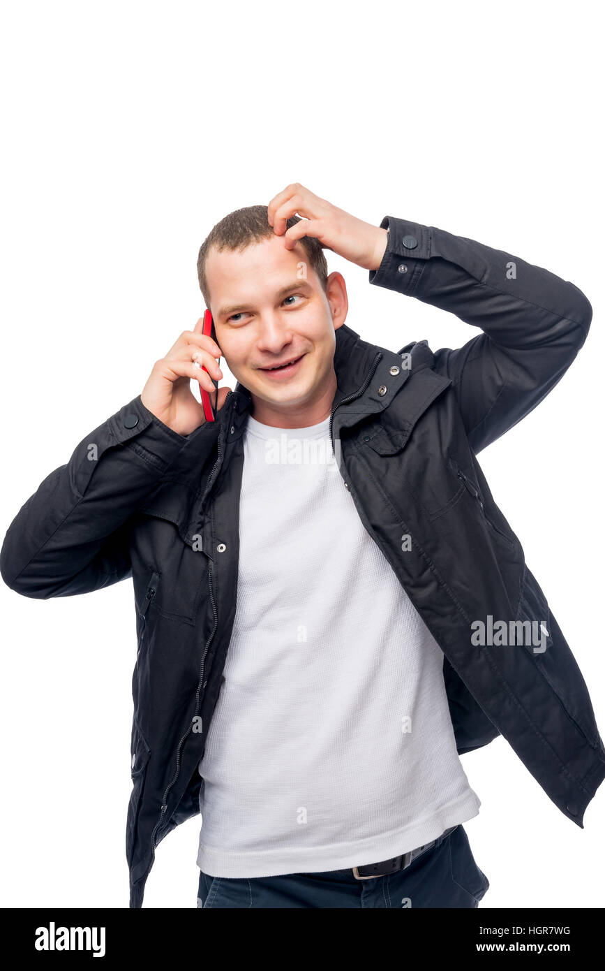 portrait of a man with a mobile phone on a white background tells Stock ...