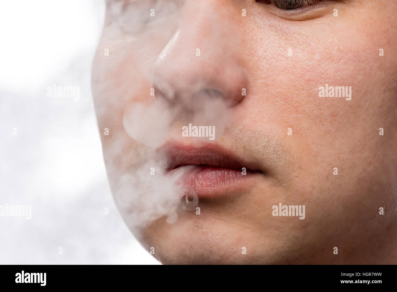 cigarette smoke, and a man's face close up on a white background Stock ...