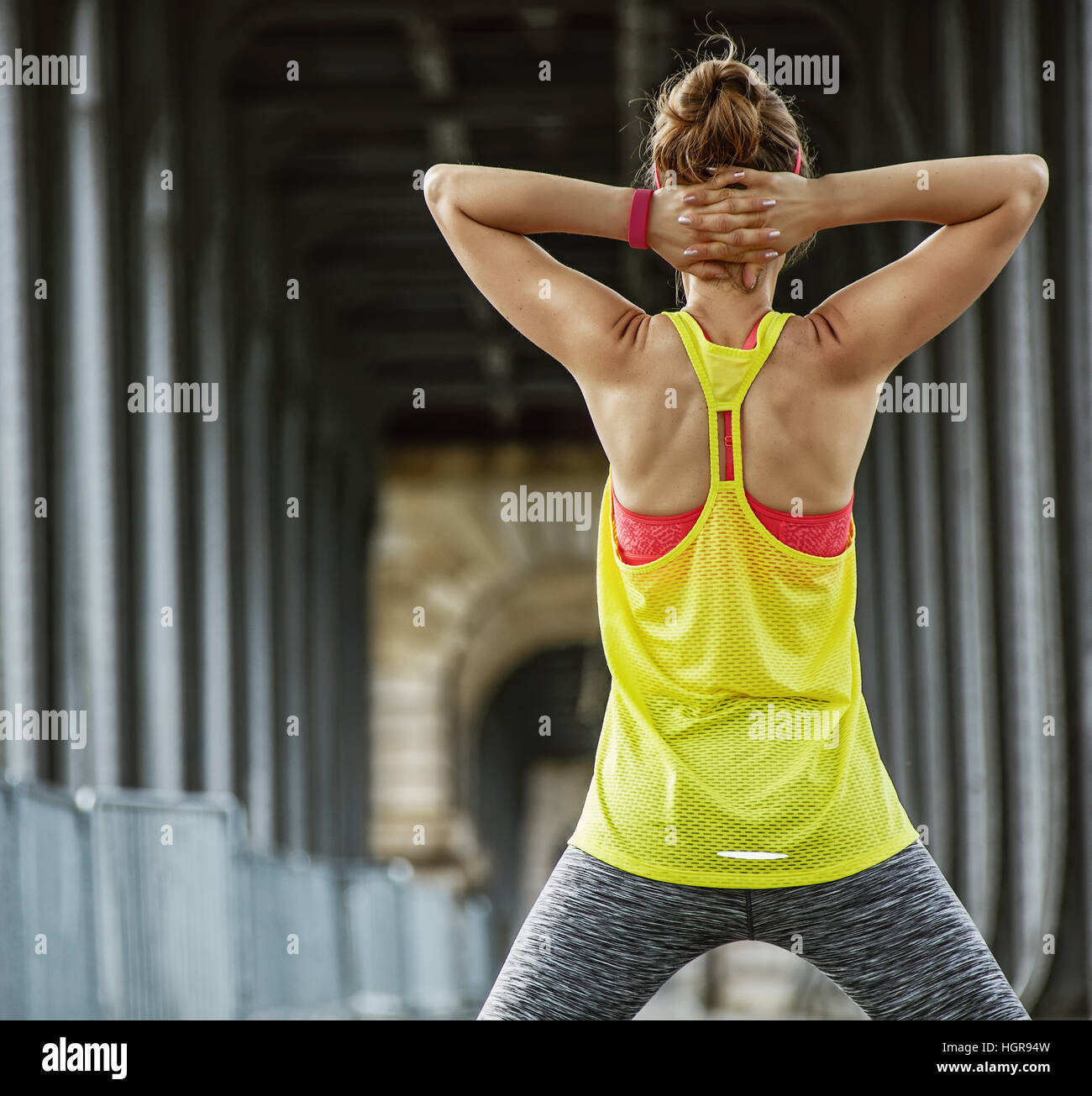 Outdoors fitness in Paris. Seen from behind young sportswoman ...