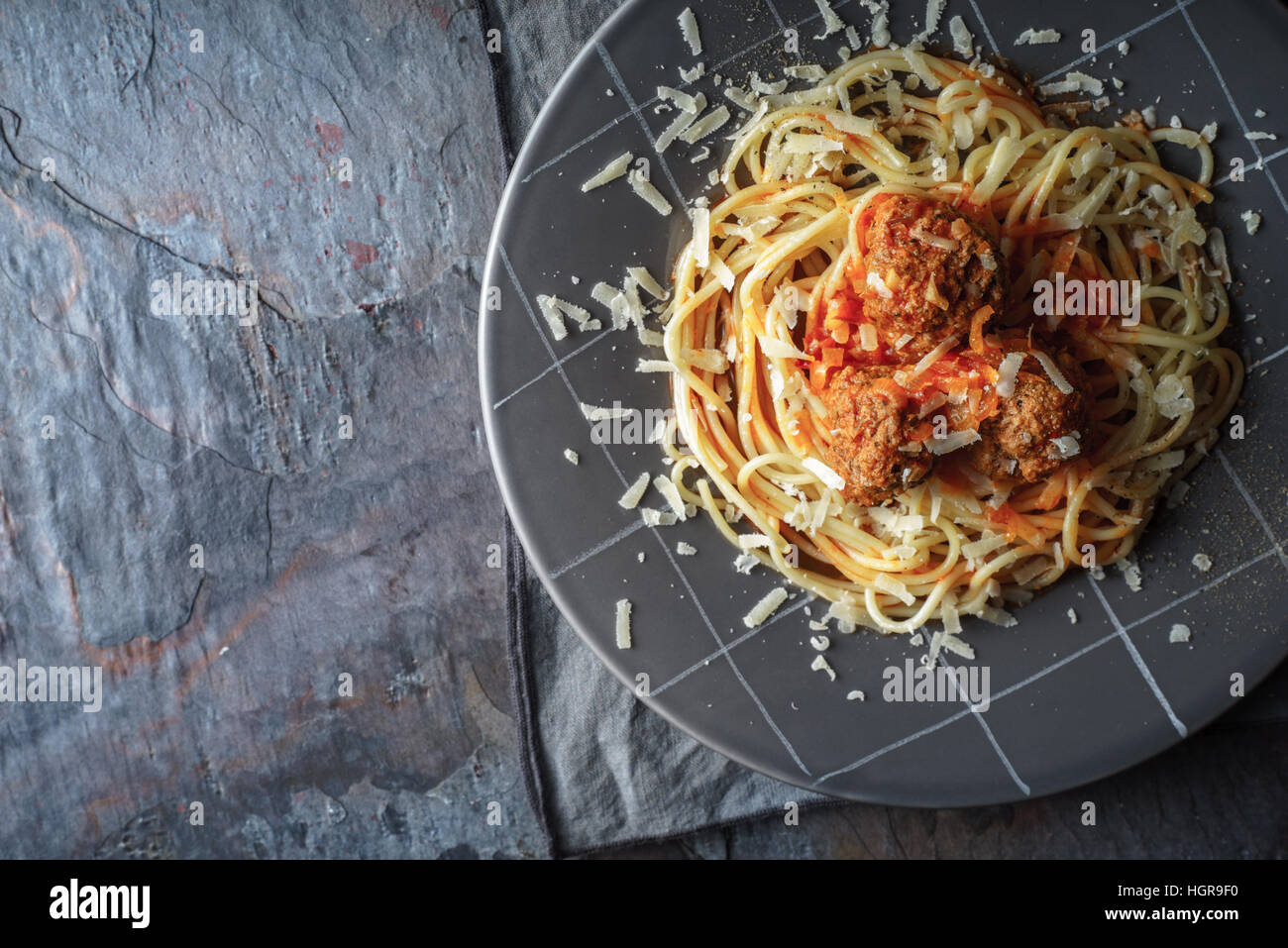Spaghetti with meatball in the grey plate on the stone background top ...
