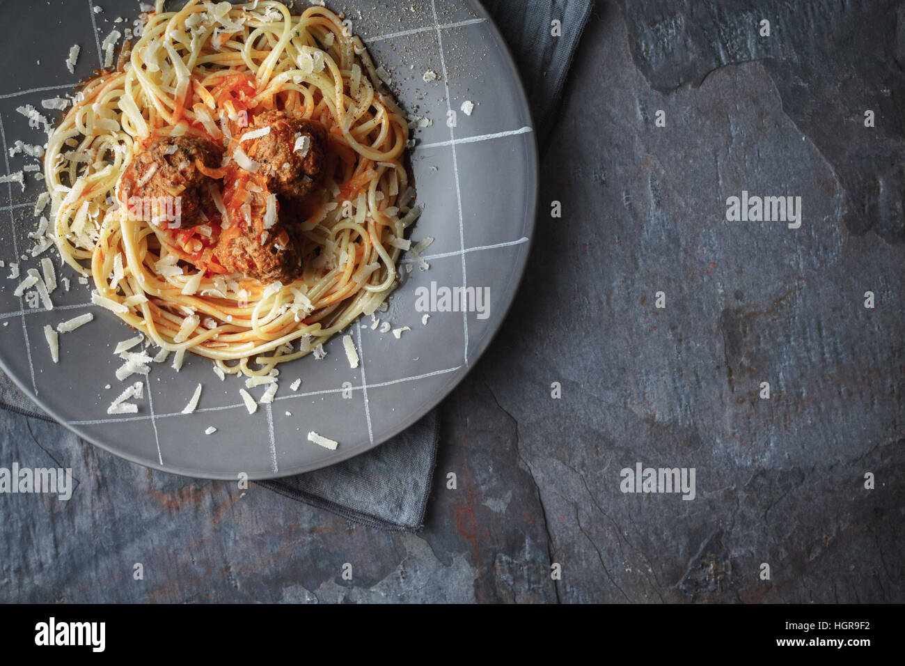 Spaghetti with meatball in the grey plate on the stone background ...