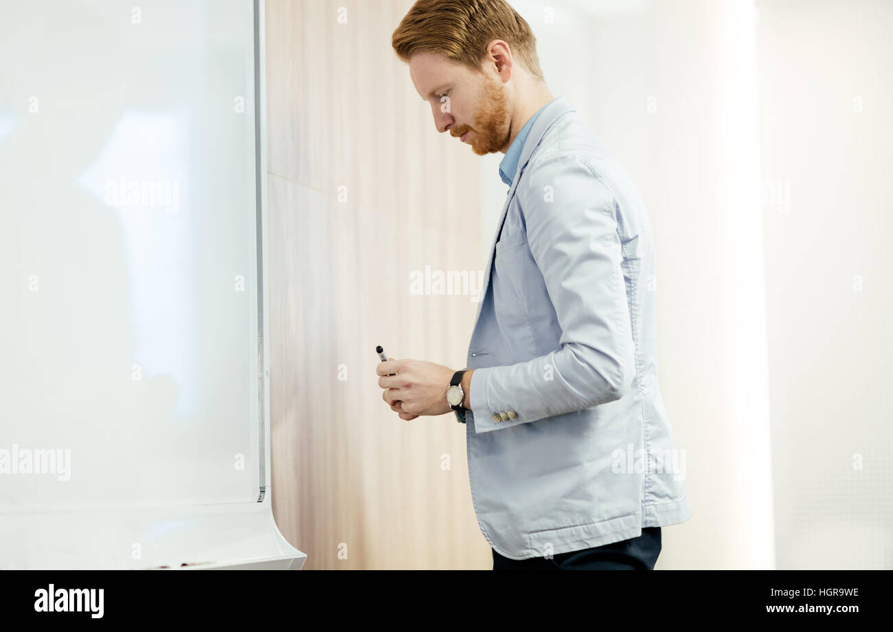 Businessman using whiteboard to present future plans Stock Photo - Alamy