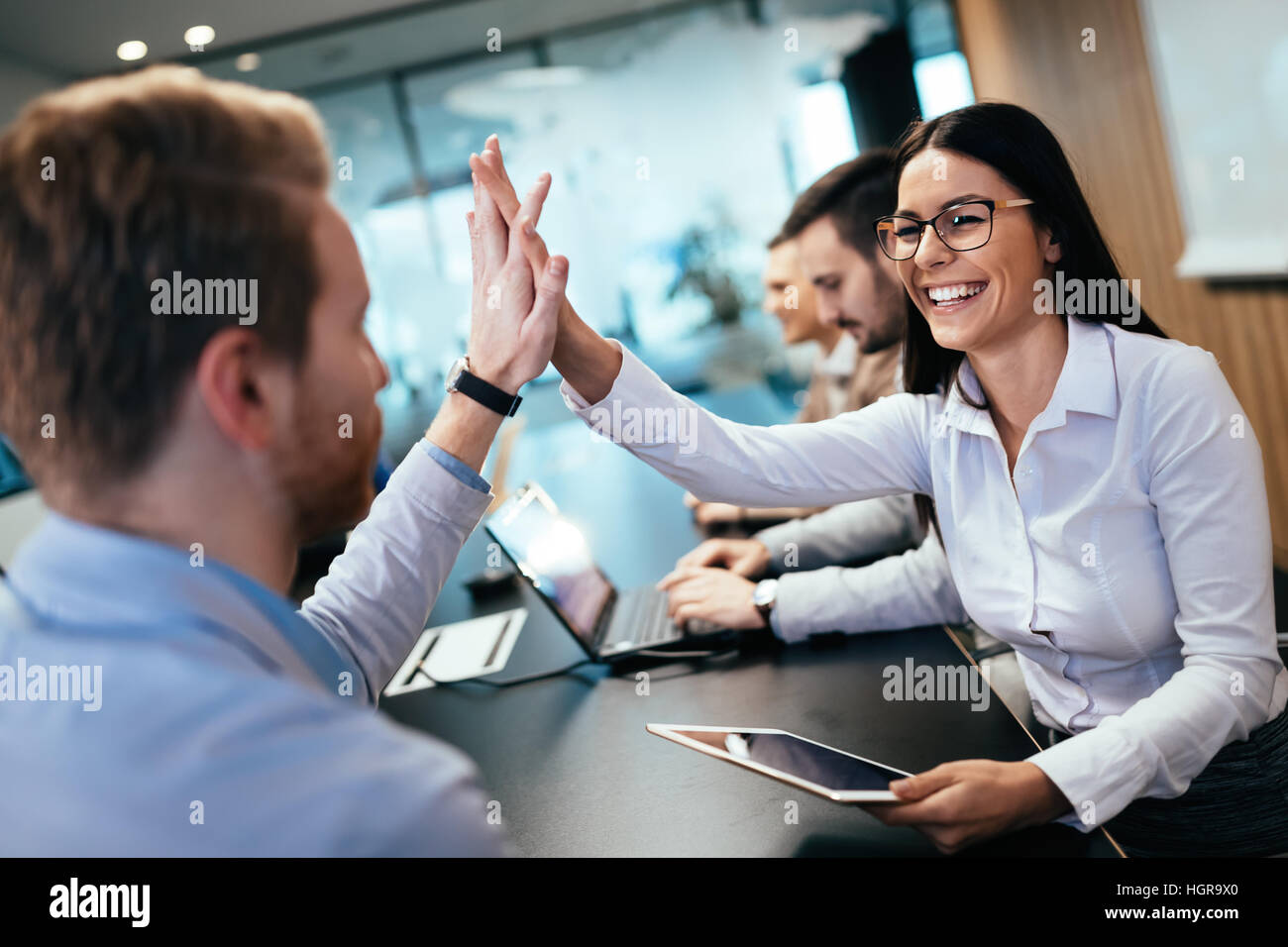 Happy professional business people achieving success together Stock ...