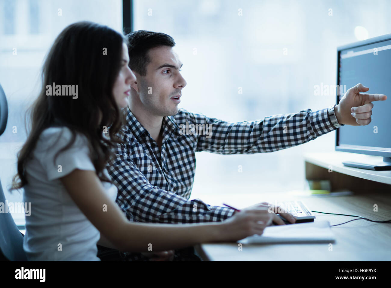 Software engineers developing applications together in office Stock ...