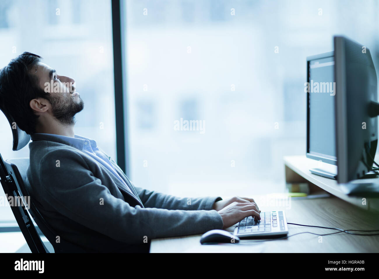 Professional software developer working in office at desk Stock Photo ...