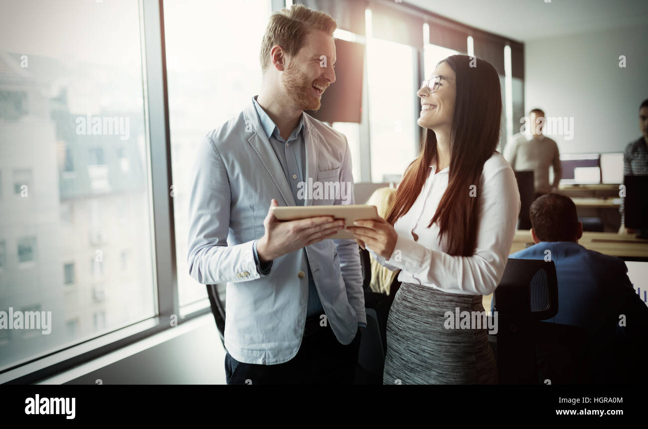 Happy cheerful business colleagues talking in modern IT office Stock ...