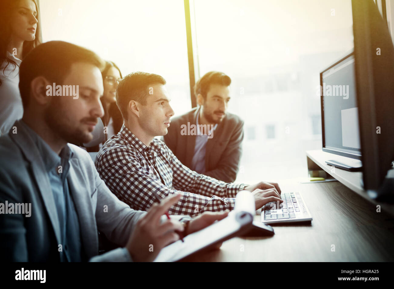 IT colleagues working on software development project in office Stock ...