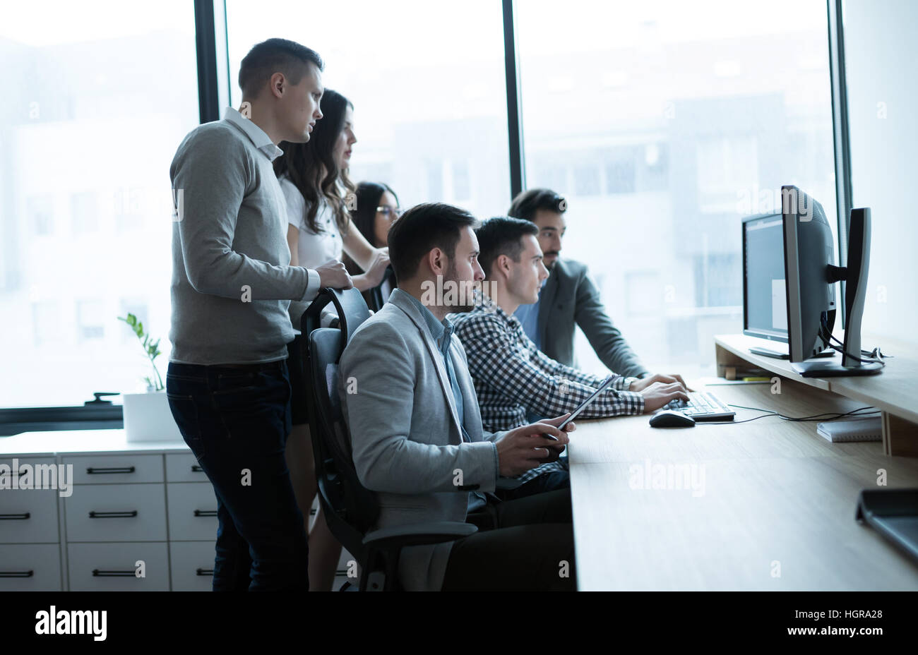 Group of business people and software developers working as a team in ...