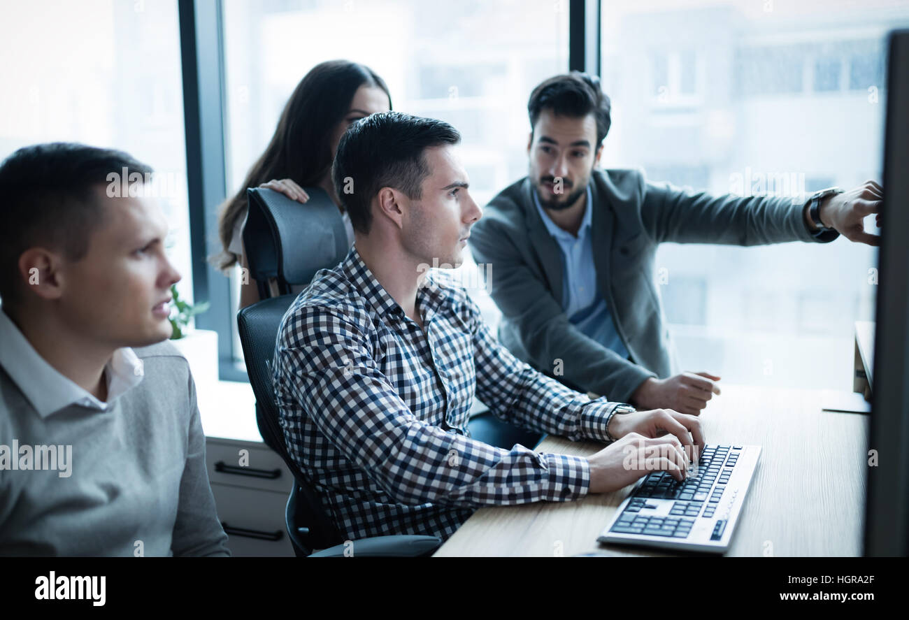 Group of business people and software developers working as a team in ...