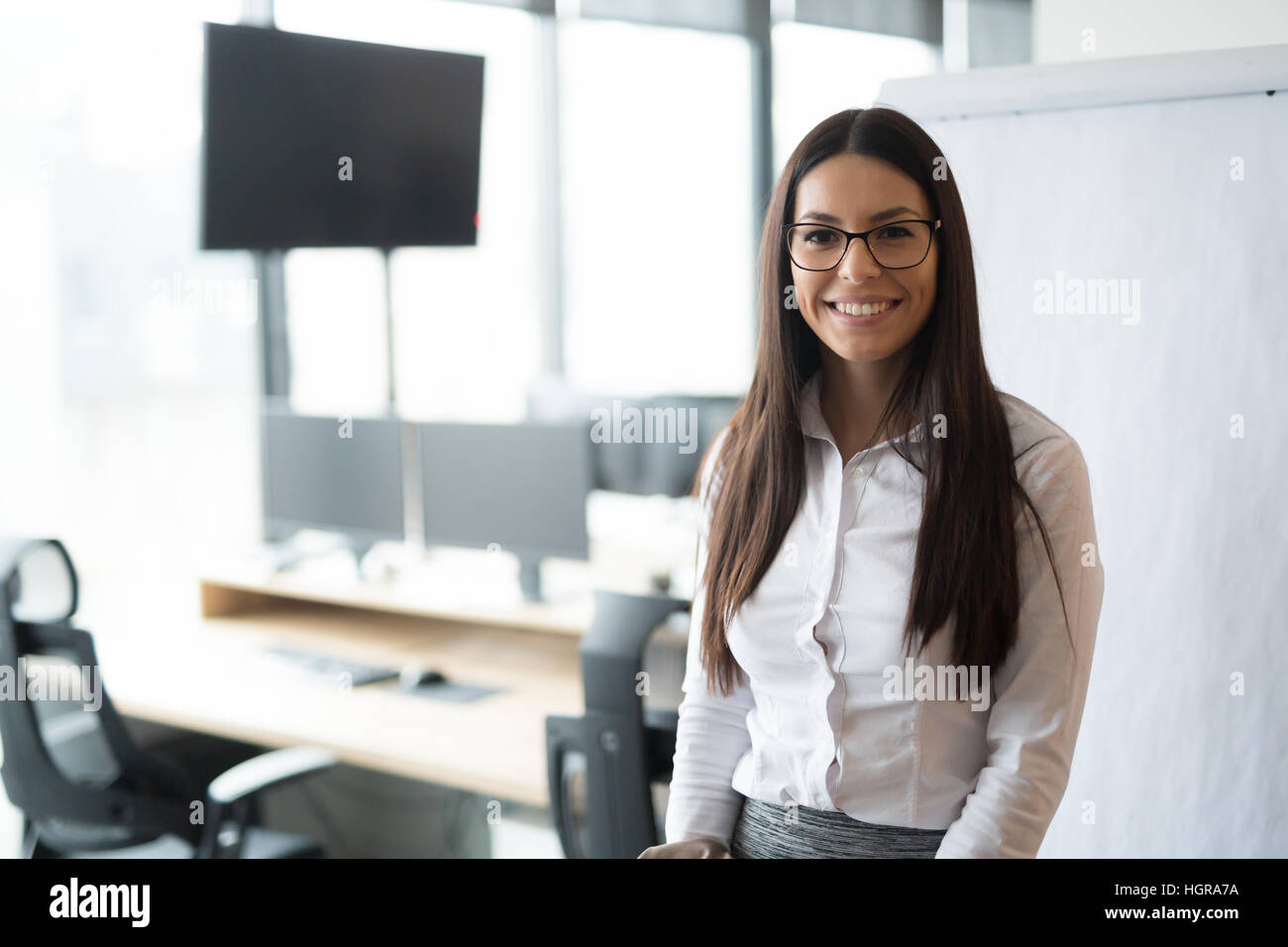 Confident businesswoman wearing glasses and smiling in office Stock ...