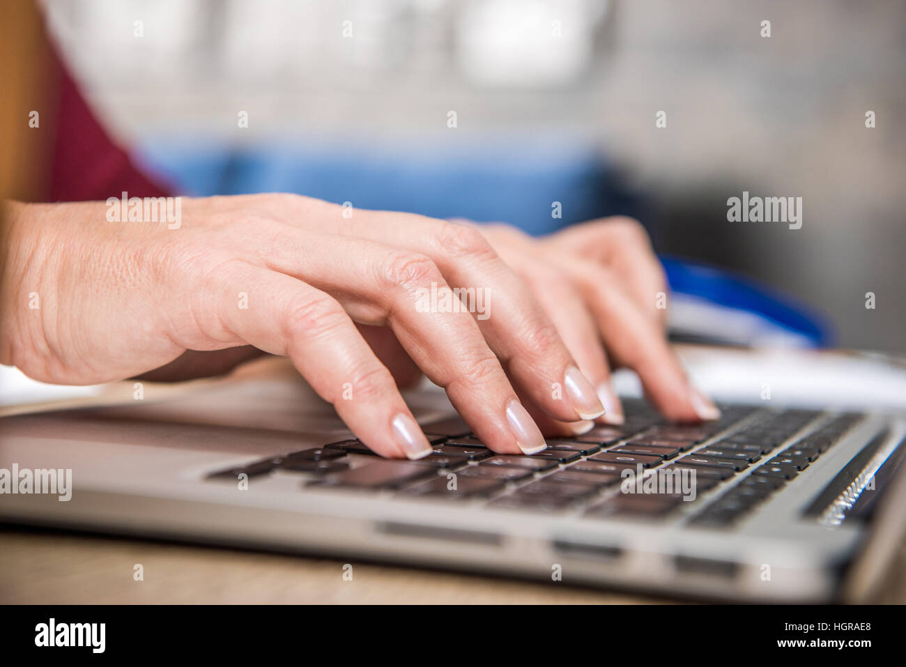 Close-up partial view of woman typing on keyboard of laptop Stock Photo ...