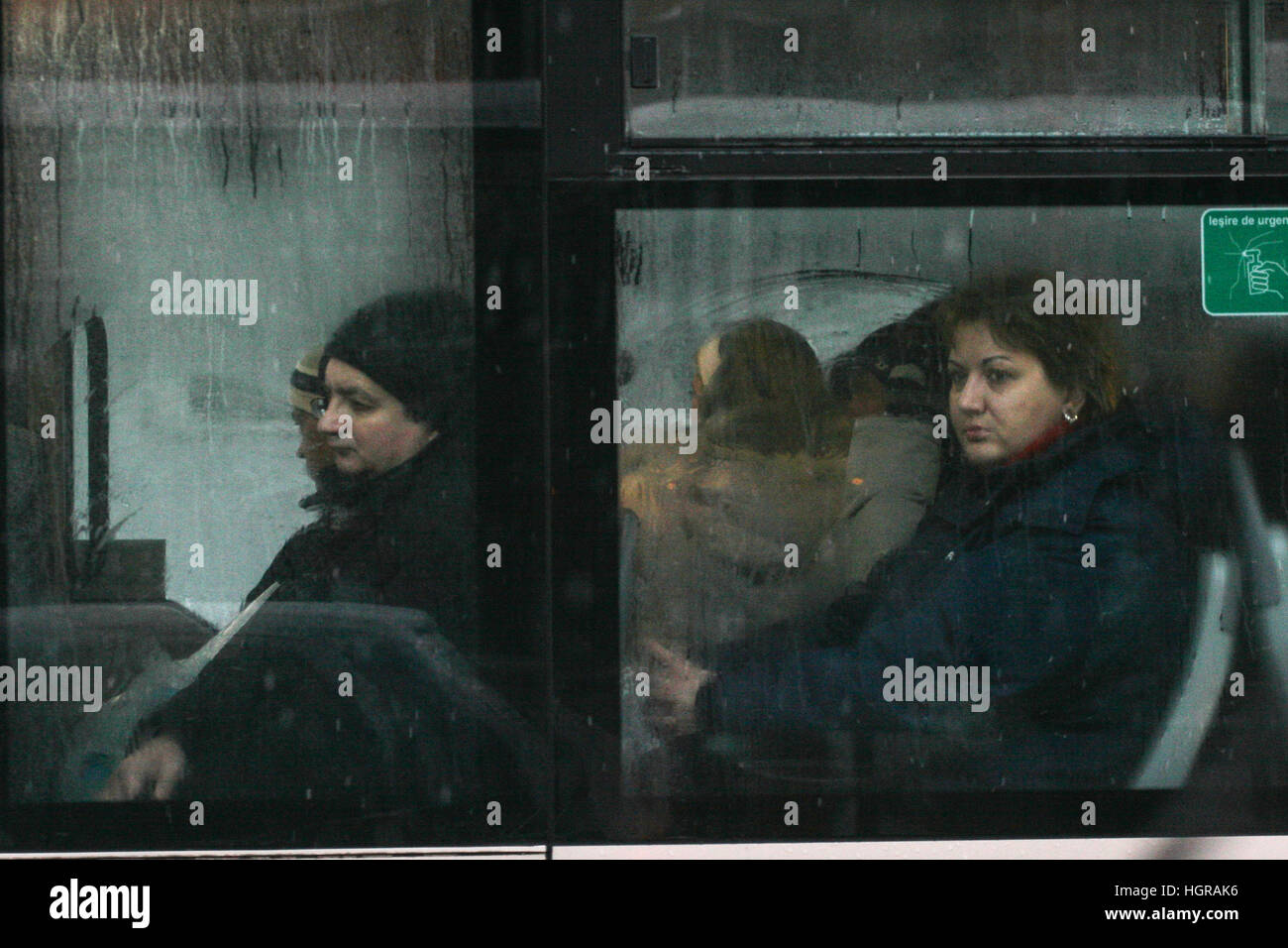 Bucharest, Romania, December 16, 2009: People are seen in a bus through ...
