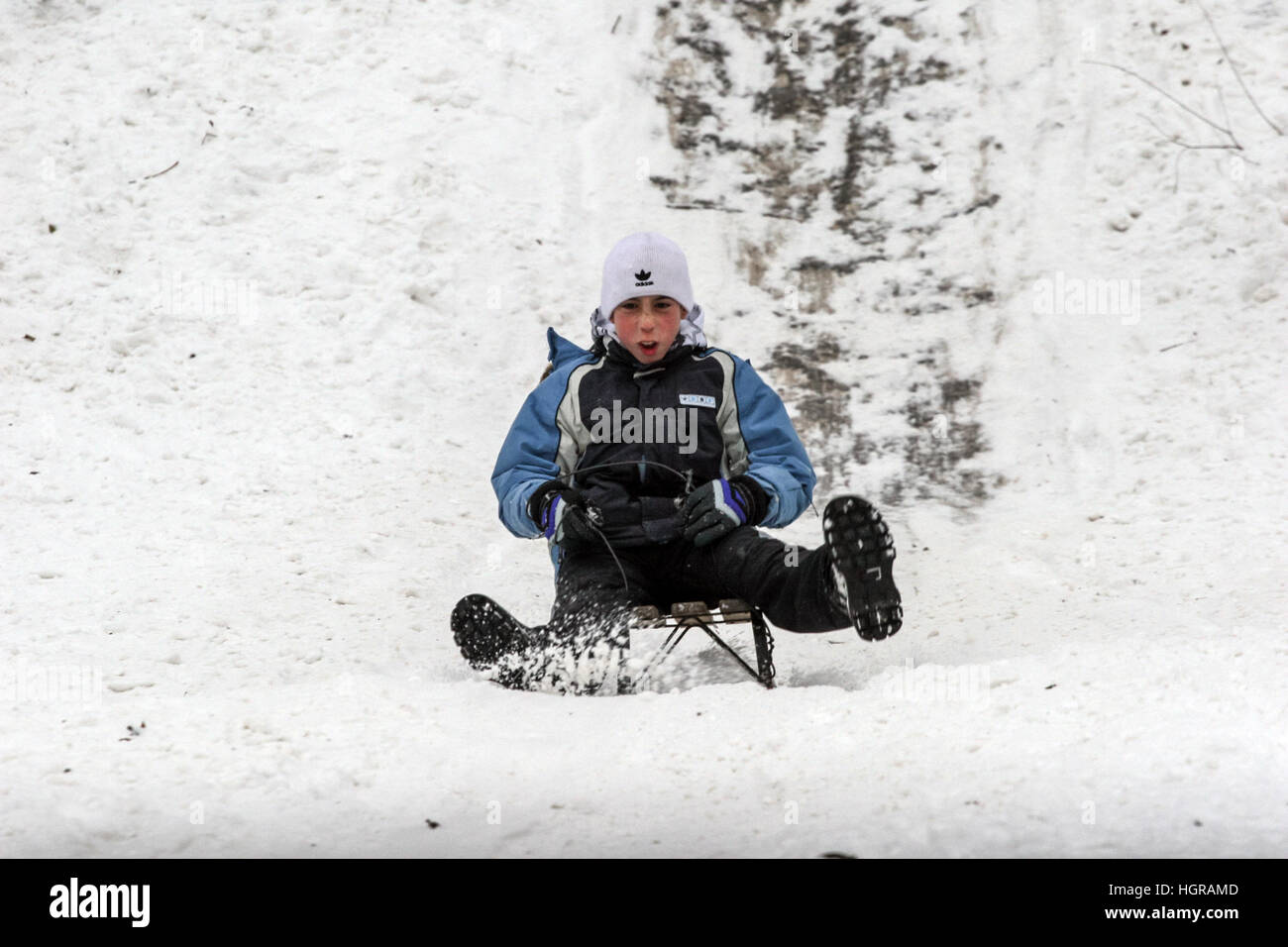Bucharest, Romania, December 20, 2009: A child sleighing on a hill in a ...