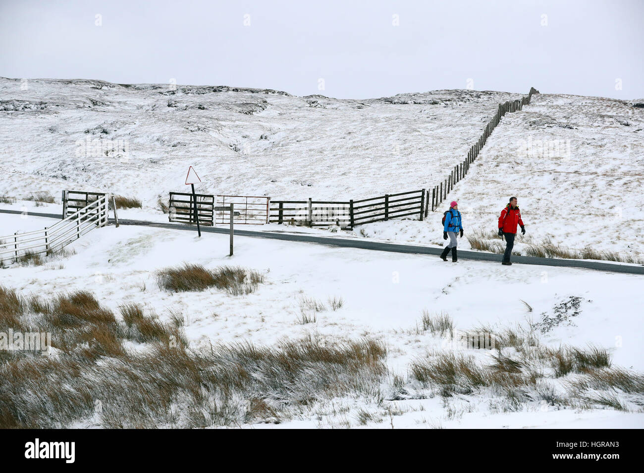 Walkers take a hike in wintry conditions at Tan Hill in North Yorkshire ...