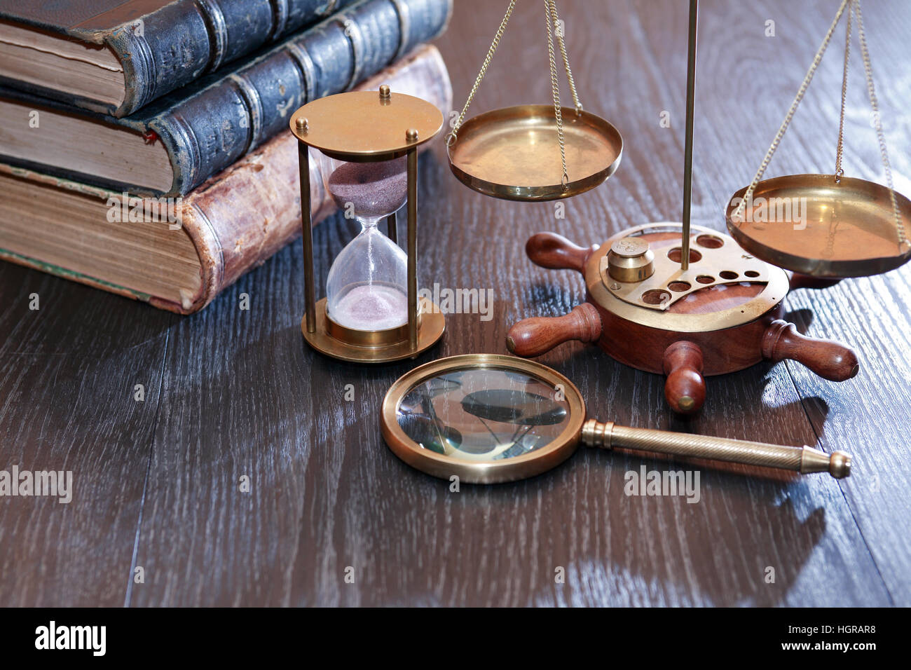 Vintage still life. Weight scale and tools on background with old books ...