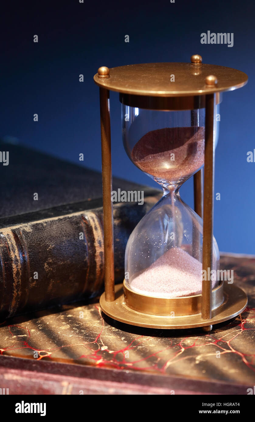 Vintage still life. Closeup of hourglass on old books Stock Photo - Alamy