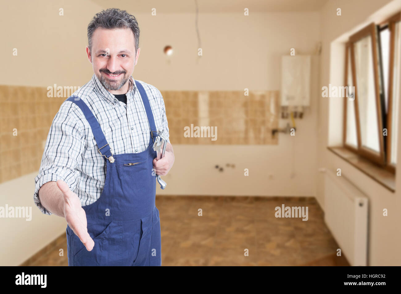 Friendly professional plumber doing handshake gesture and smiling ...