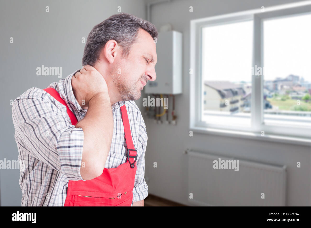 Tired plumber neck pain injury hi-res stock photography and images - Alamy