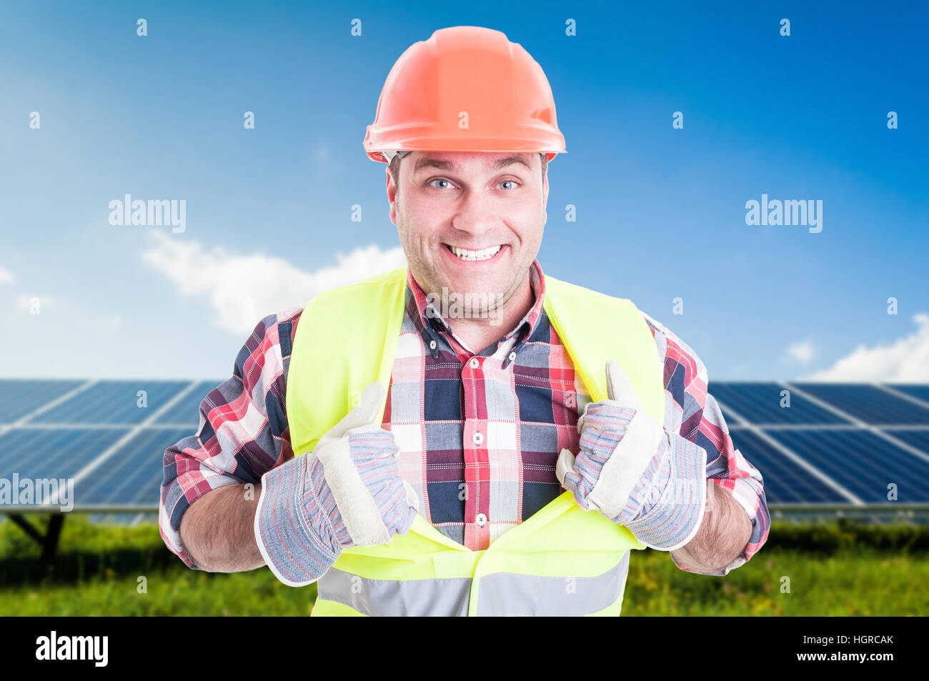 Cheerful male engineer acting like super hero while being at solar ...
