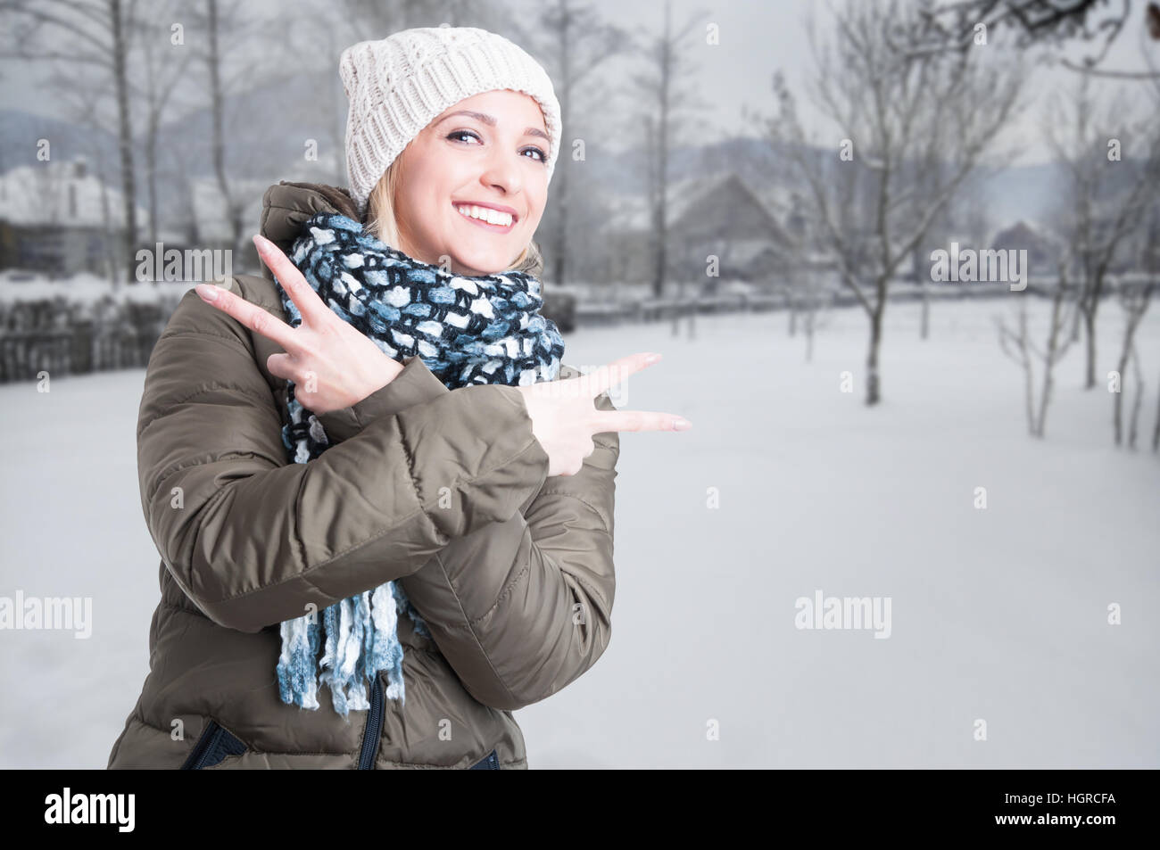 Happy female with arms crossed showing double peace sign relaxing ...
