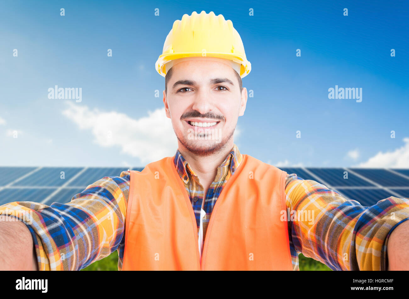 Confident engineer taking a self portrait with ecologic panels in ...