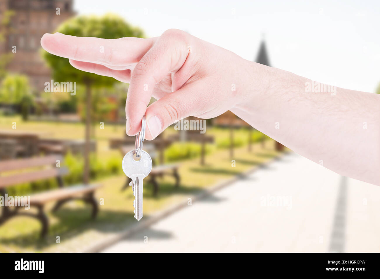 Closeup of man realtor showing apartment key of a new rental house as ...