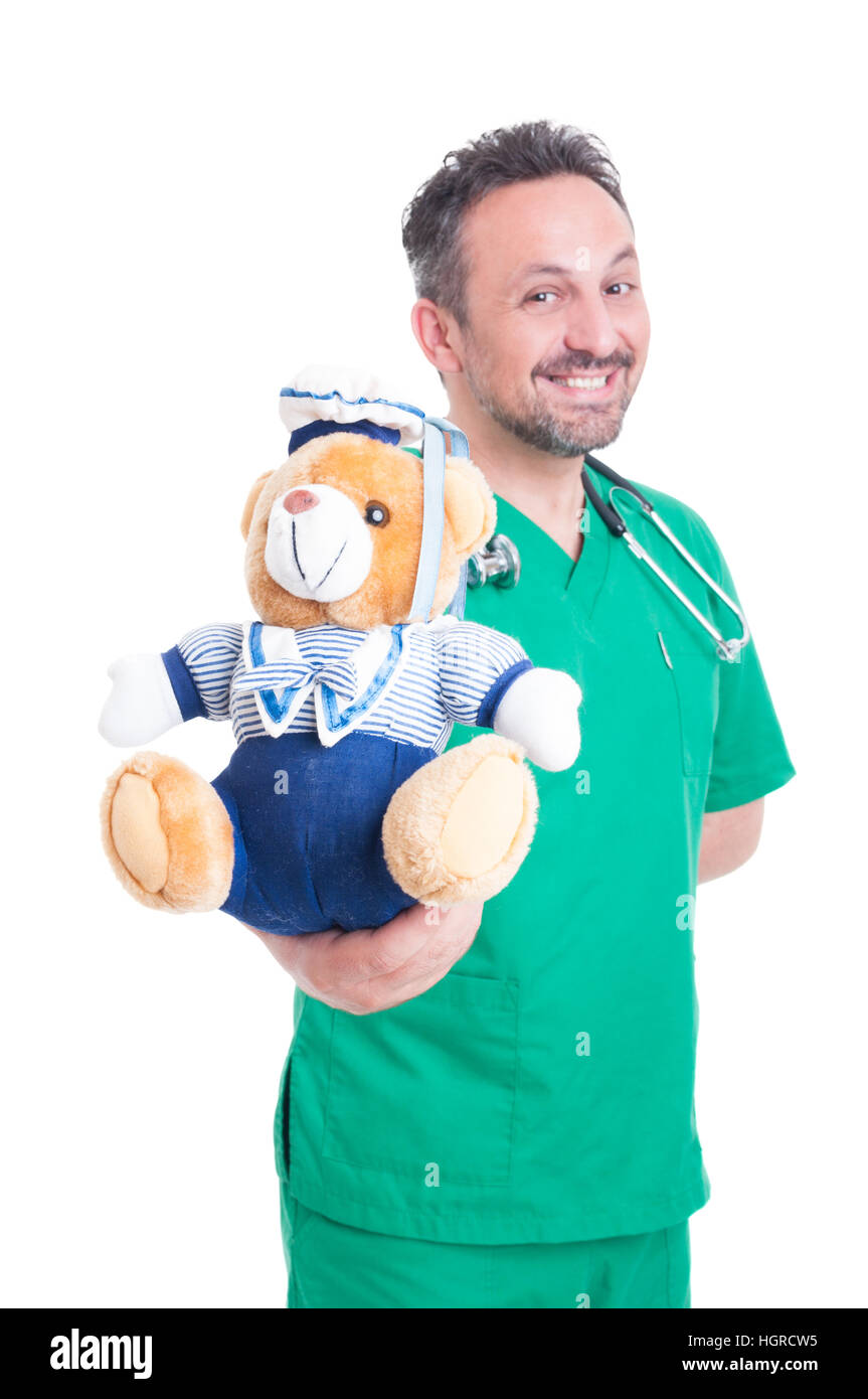 Friendly pediatrician doctor with teddy bear looking happy on white ...