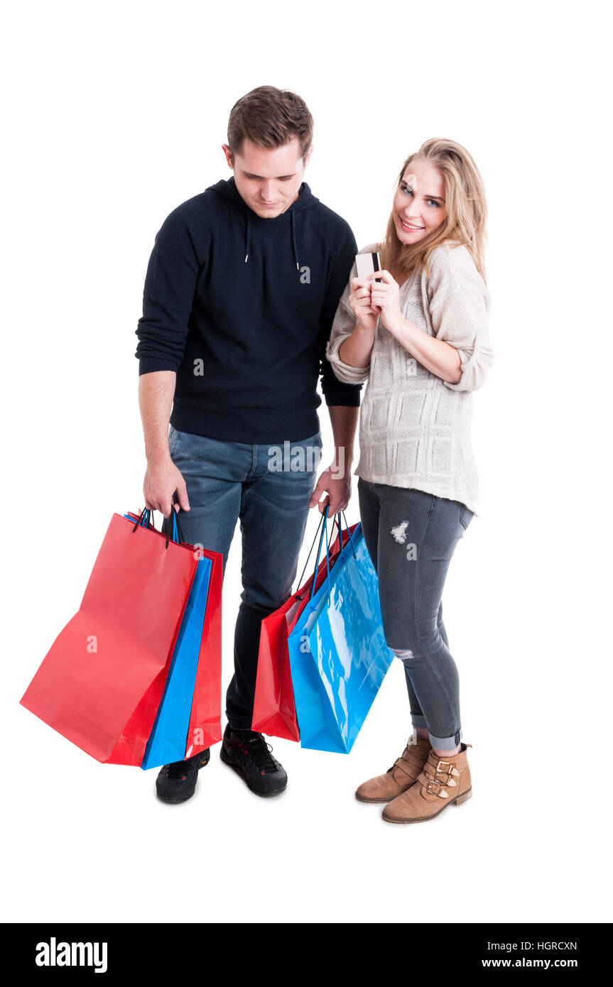 Happy woman holding credit card and sad man carrying bunch of shopping ...