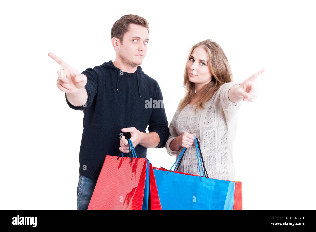Couple holding shopping bags making no gesture with index fingers ...
